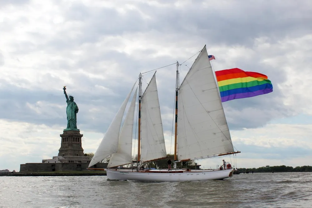 Schooner Adirondack sailing with a huge PRIDE flag off the back sail ...